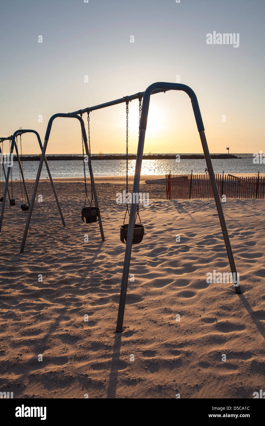 A swing at New Buffalo beach in sunset over Michigan Lake, USA Stock ...
