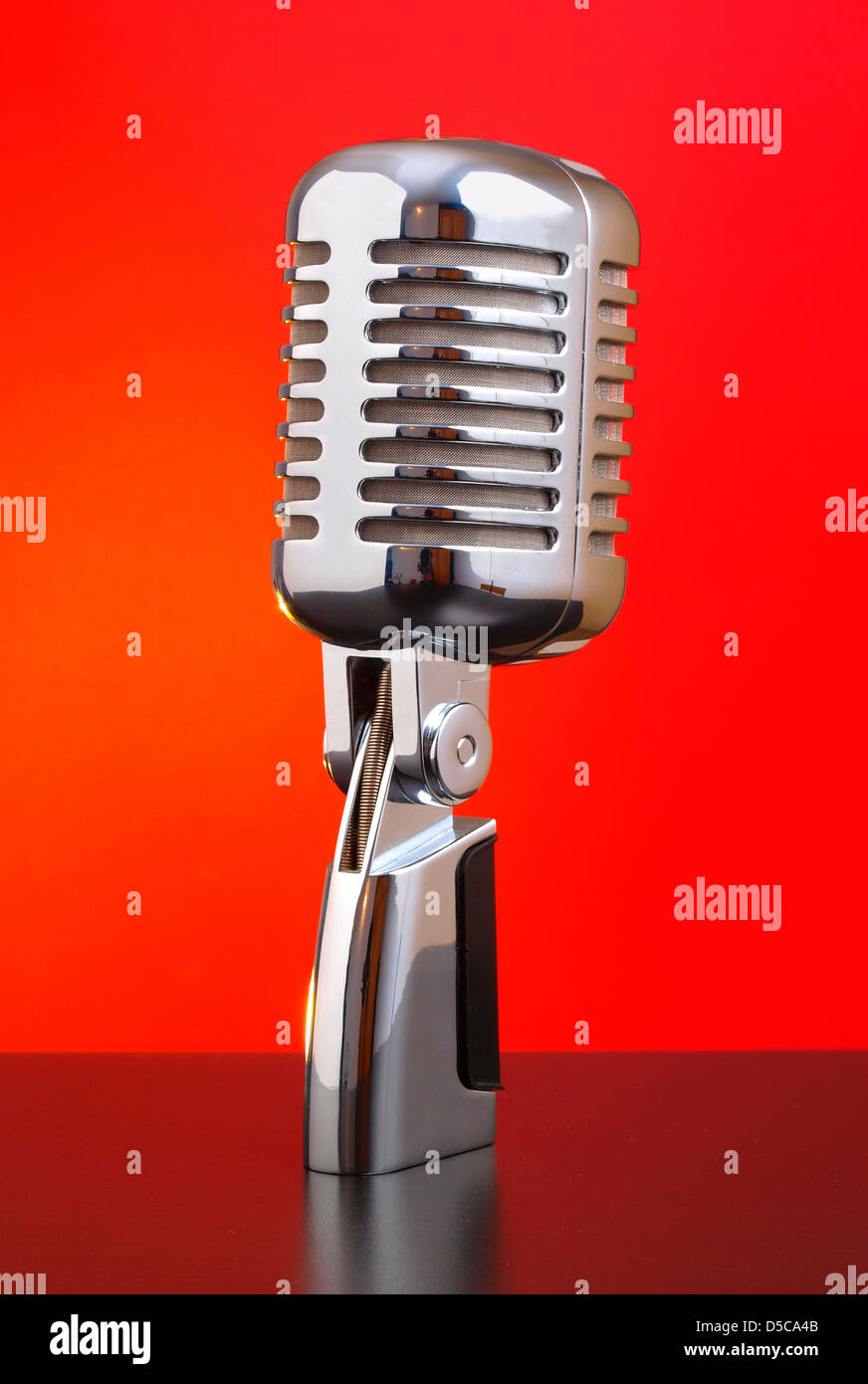 Classic microphone on red background Stock Photo - Alamy