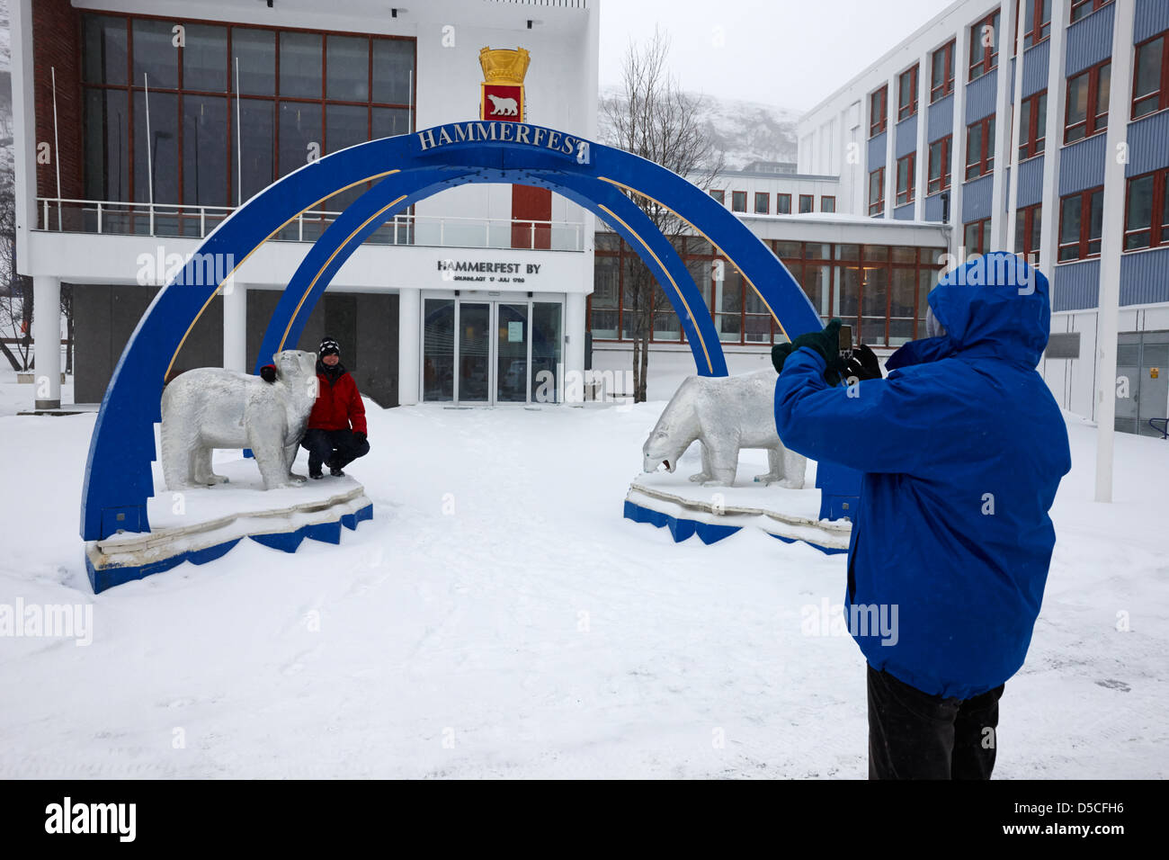 tourists take photos outside hammerfest radhus kommune offices local ...
