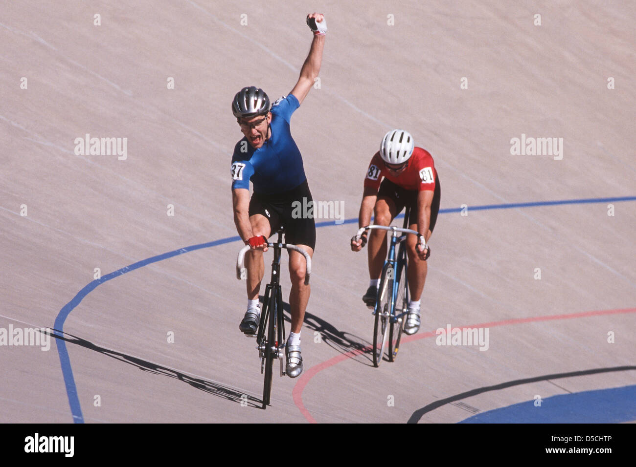 Male cyclist winning on the velodrome Stock Photo - Alamy