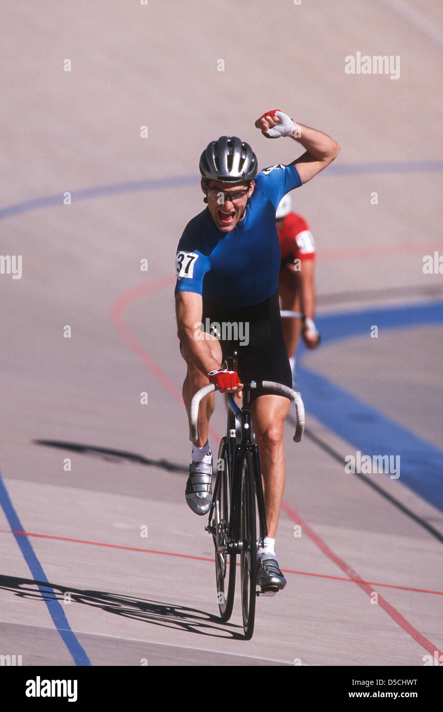 Male cyclist winning on the velodrome Stock Photo - Alamy