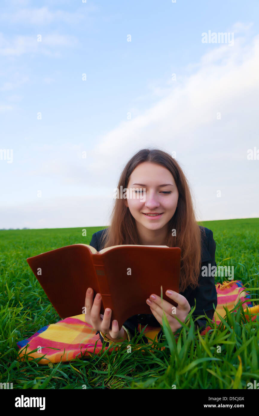 Teen girl reading the Bible outdoors at sunset time Stock Photo - Alamy
