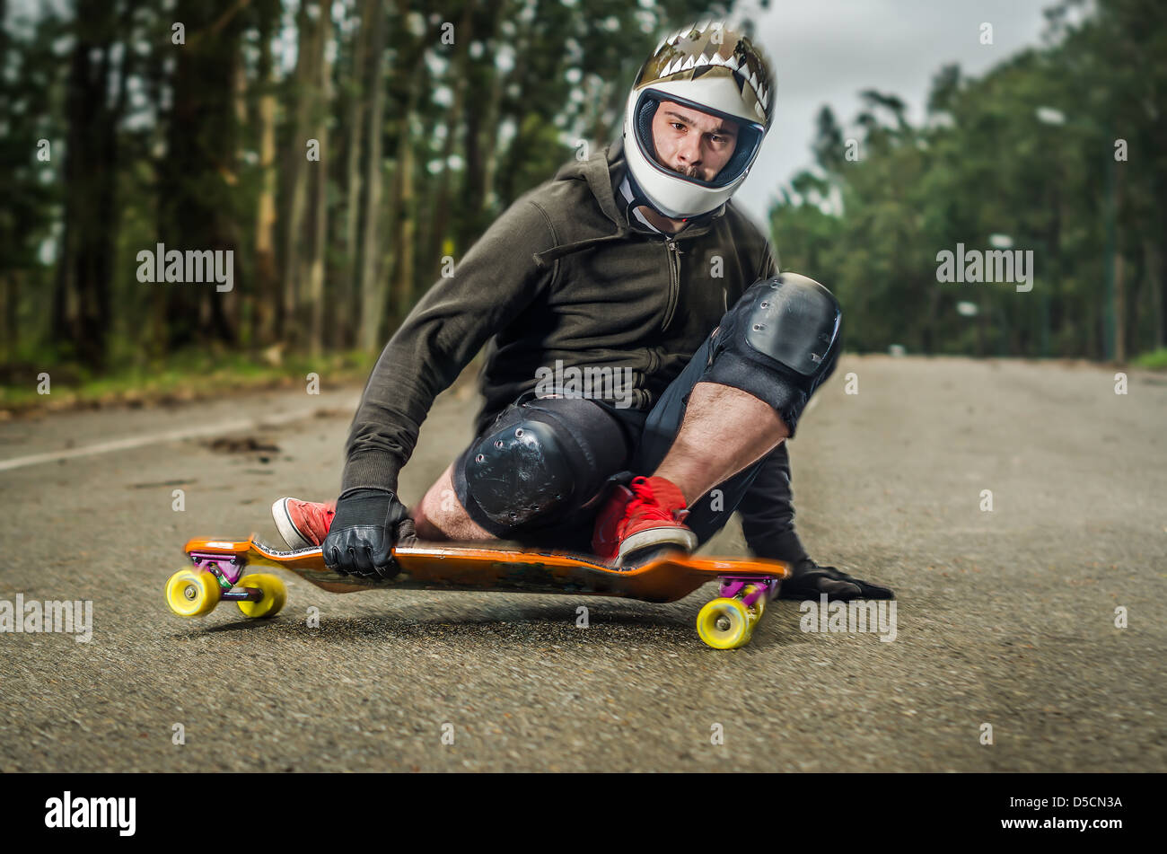 Downhill skateboarder in action on a asphalt road Stock Photo - Alamy