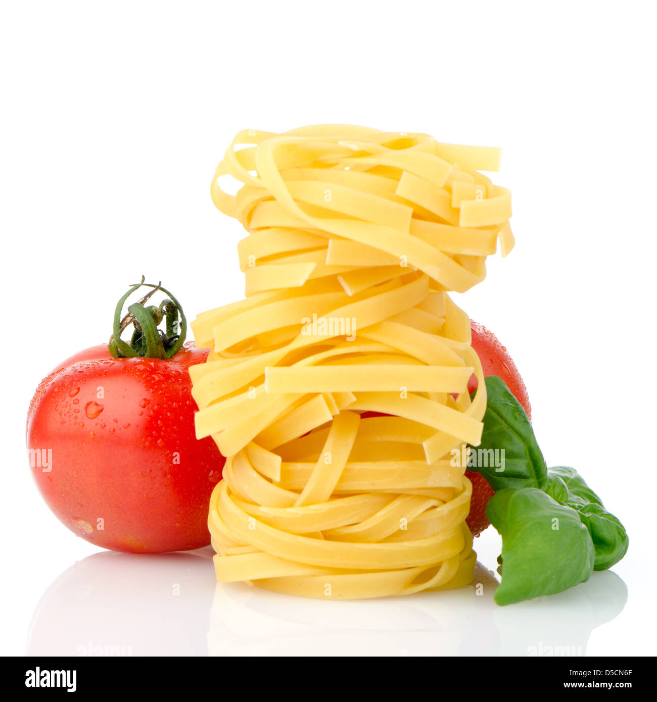 Composition of: tomato, tagliatelli, garlic and basil Isolated on white ...