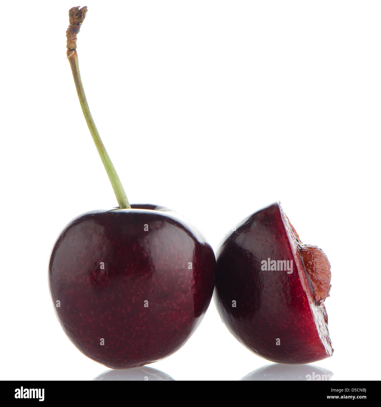 Red cherries on white reflective background Stock Photo - Alamy