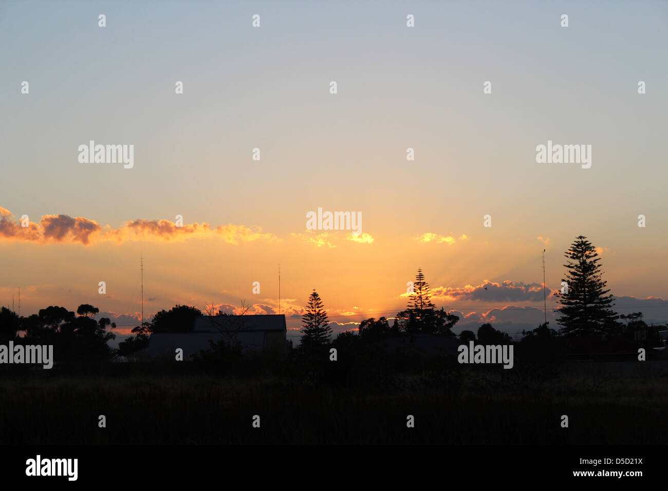 The first rays of the sun peep over the city horizon on a fine morning ...