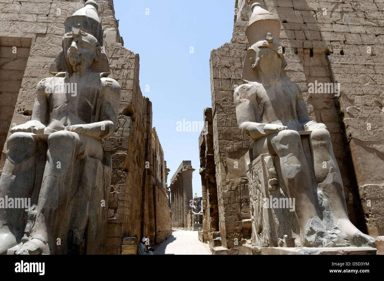 Egypt. Guard in front of the two enormous seated colossi of Ramses that ...