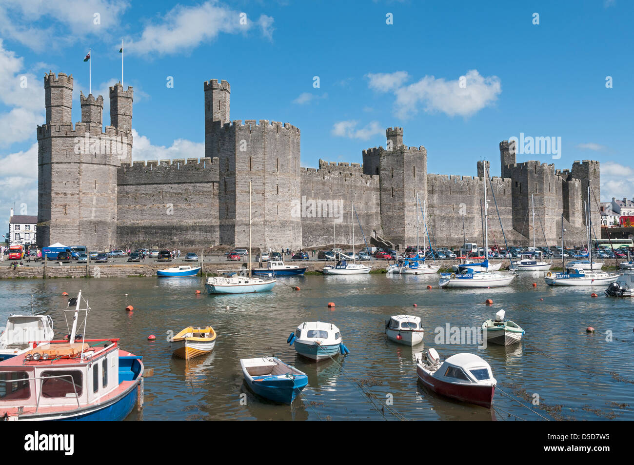 Wales, County Gwynedd, Caernarfon Castle, Welsh flags atop Eagle Tower ...