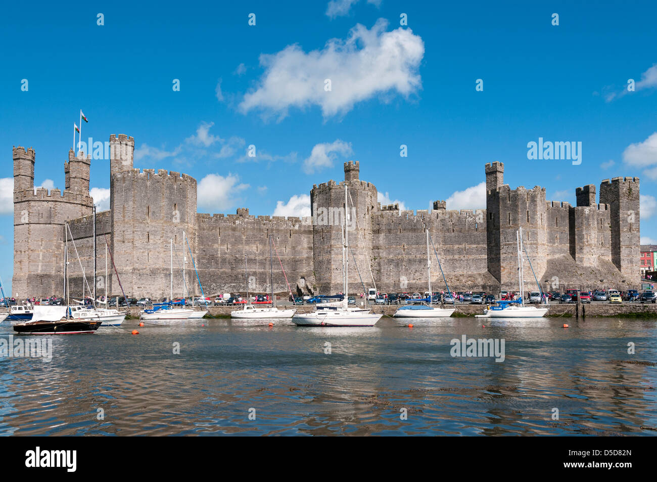 Wales, County Gwynedd, Caernarfon Castle, Welsh flags atop Eagle Tower ...