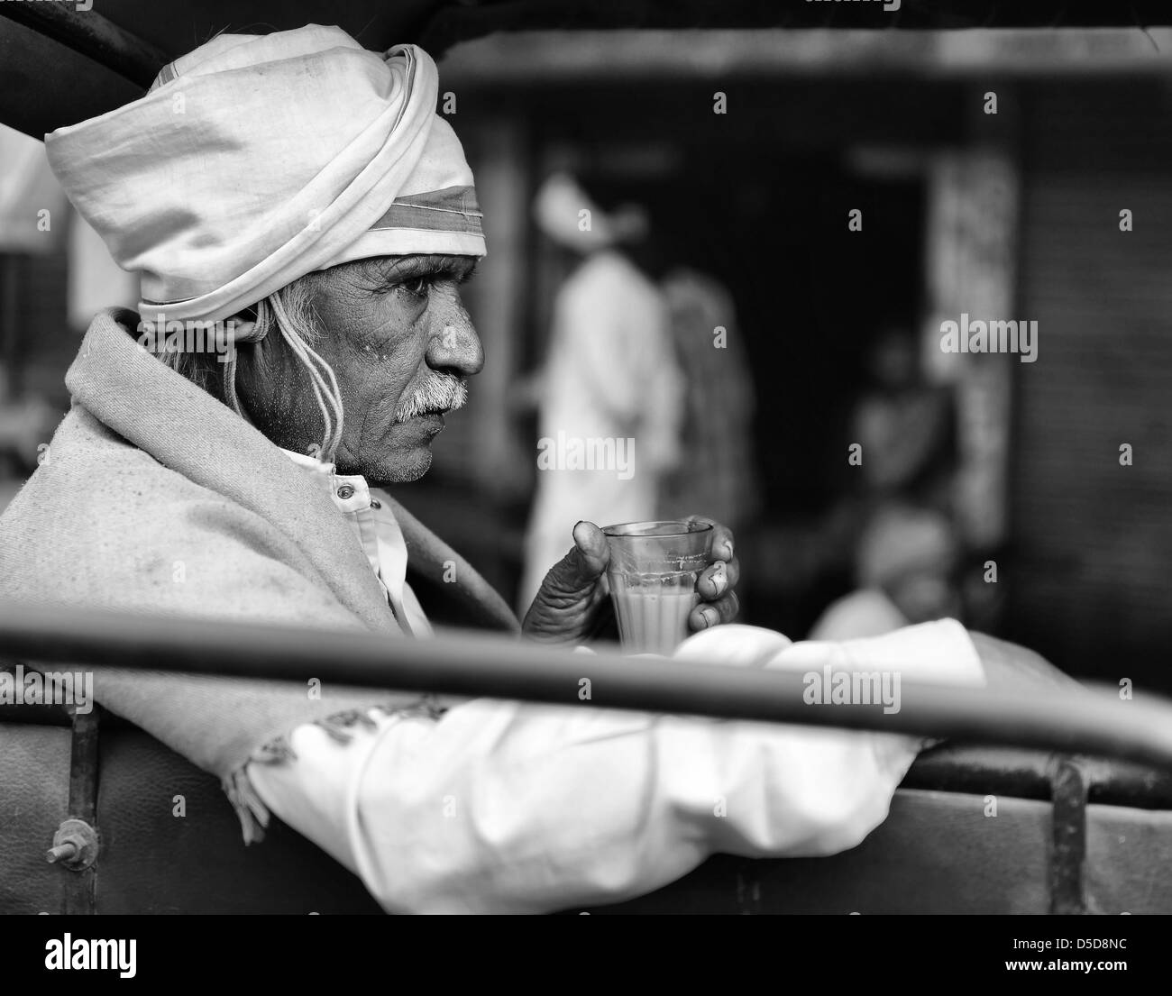 An Indian Rickshaw Puller having a cup of tea early in the morning at ...