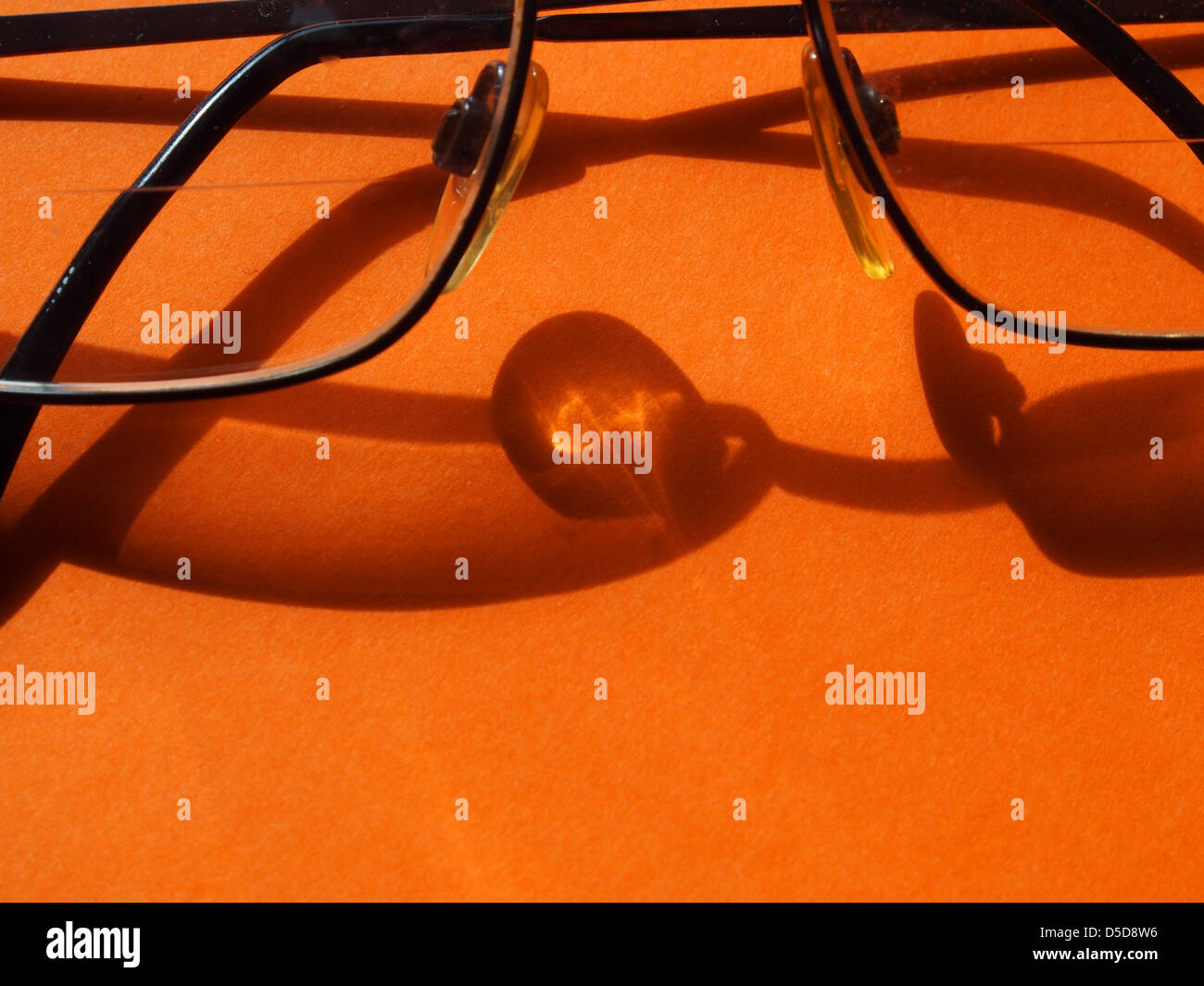 male wire-rim glasses isolated on an orange background Stock Photo - Alamy