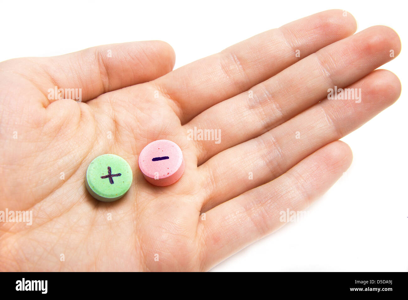 Tablets with plus and minus sign and female hand isolated on white ...