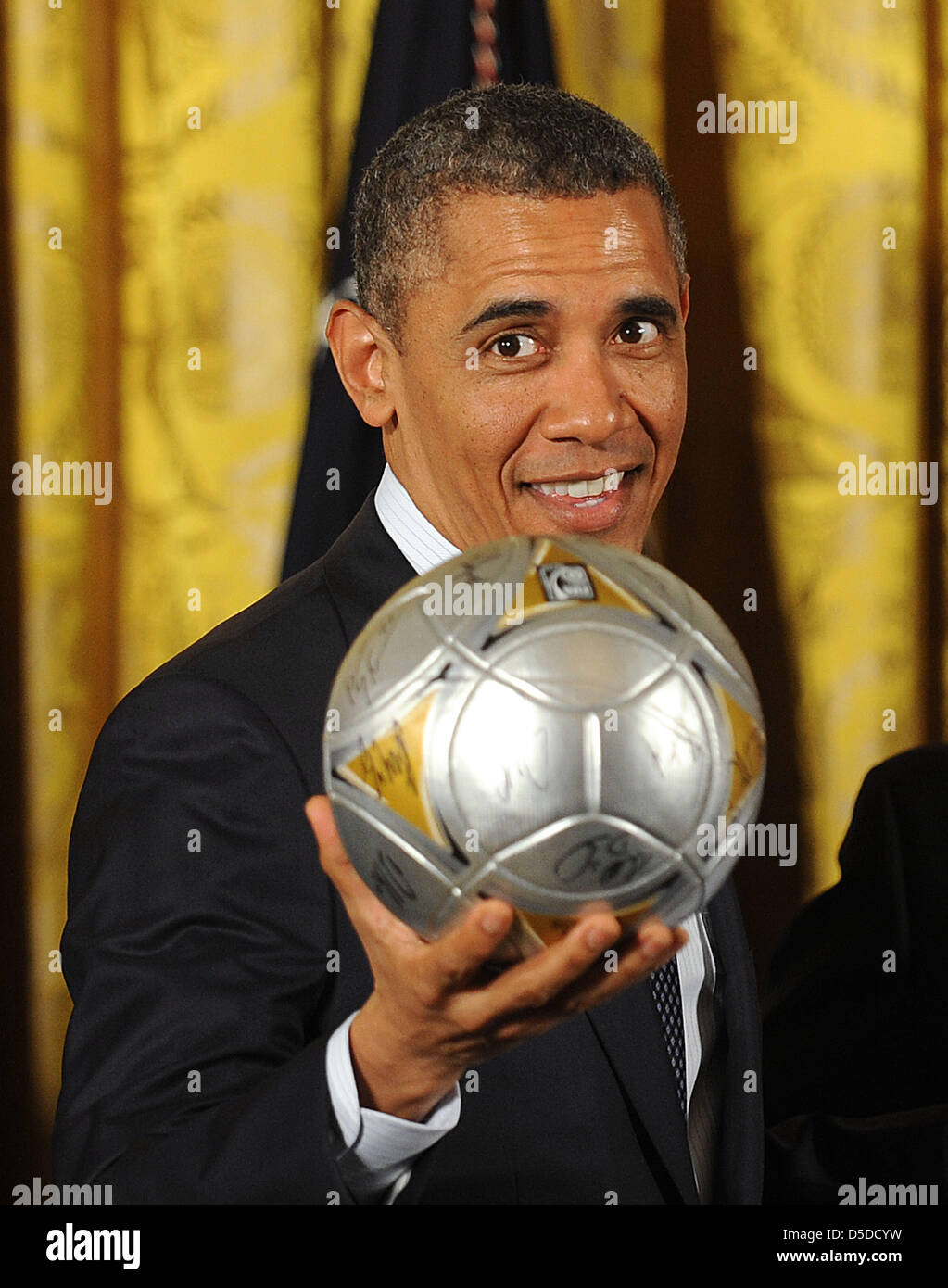 United States President Barack Obama holds a soccer ball as he welcomes ...