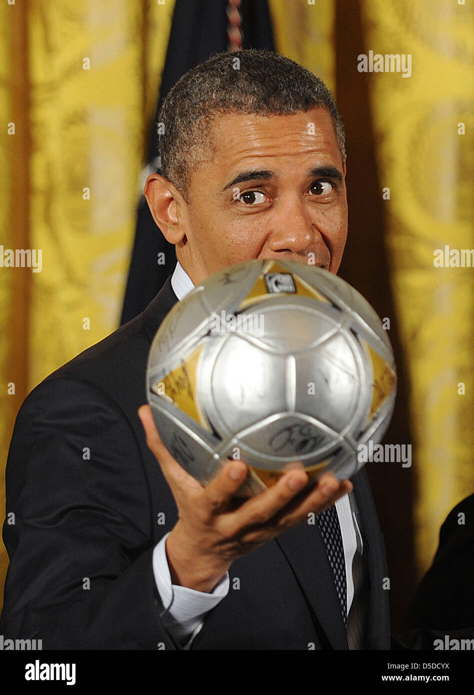 United States President Barack Obama holds a soccer ball as he welcomes ...