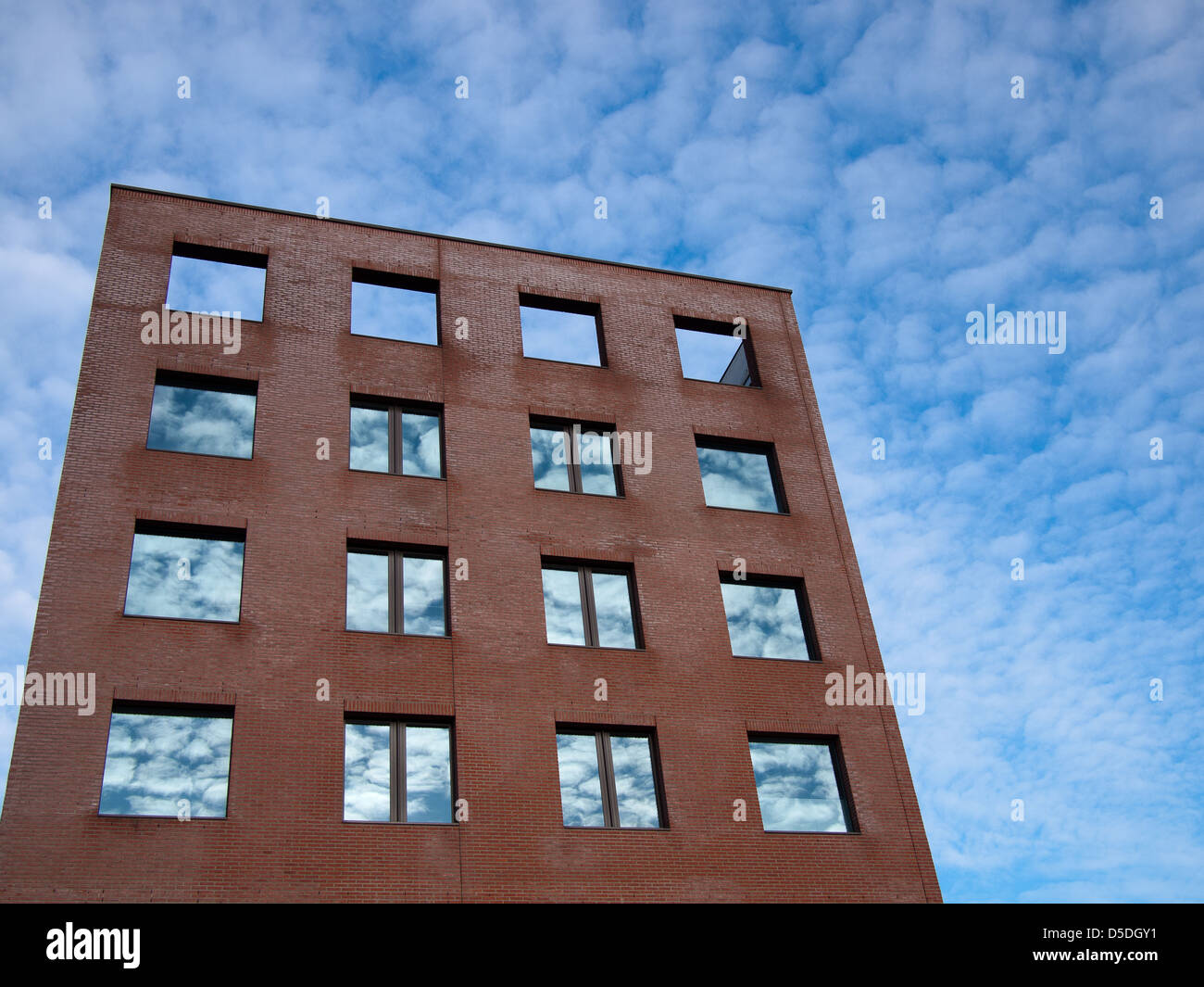 Windows to the sky. Building against a blue, slightly clouded, sky with ...