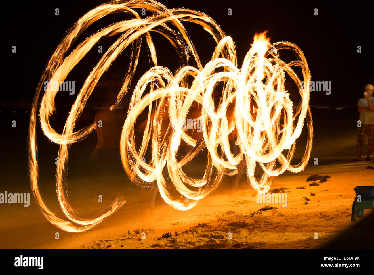 Fire artist showing off his art on Alona Beach Stock Photo - Alamy