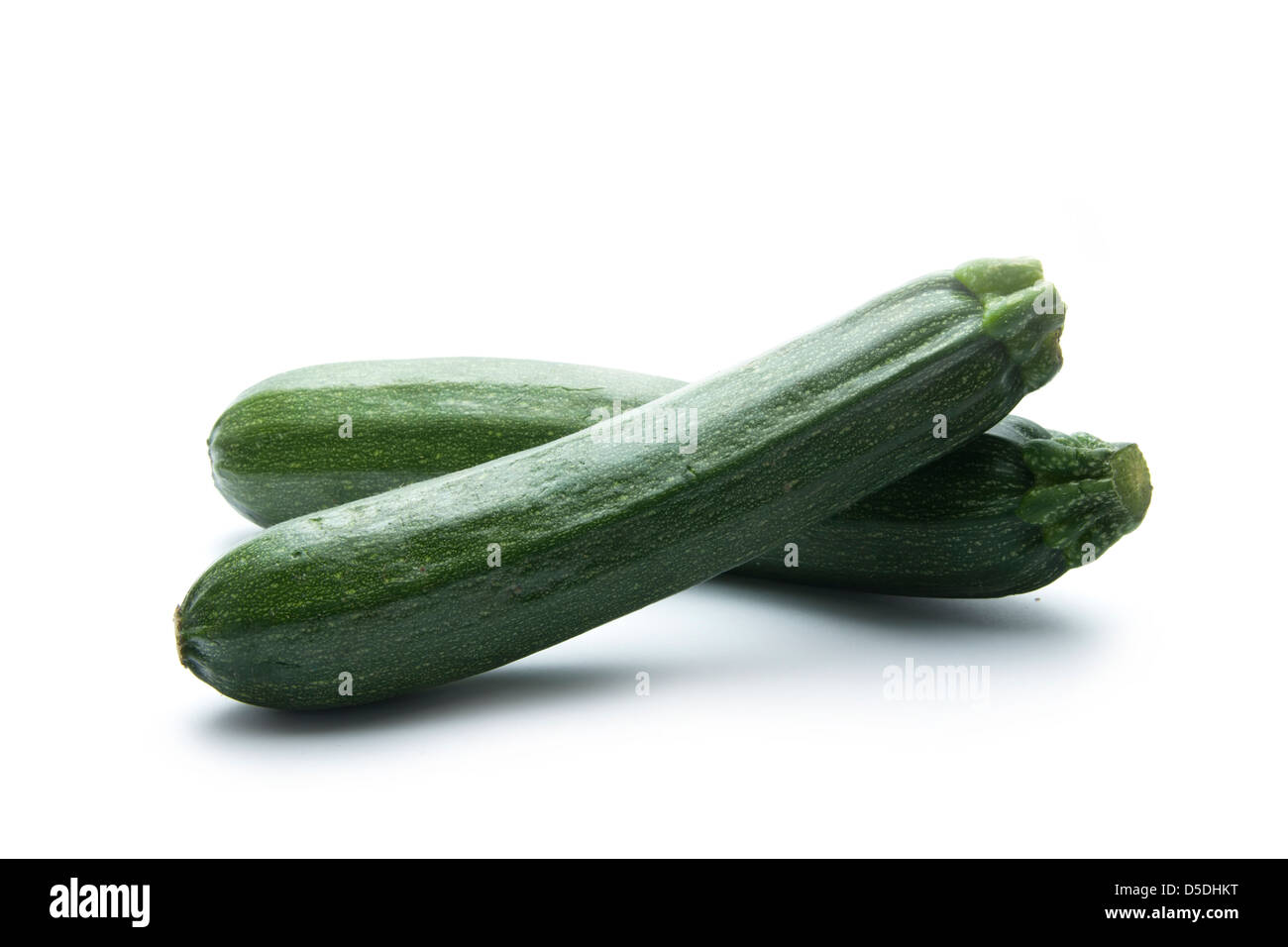 pair of green zucchini isolated on white background Stock Photo - Alamy