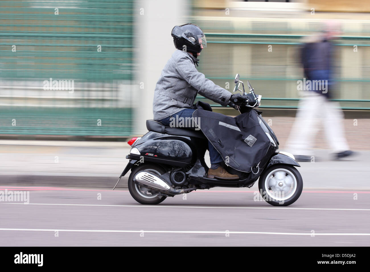 A motorcyclist riding along a road in London, England Stock Photo - Alamy