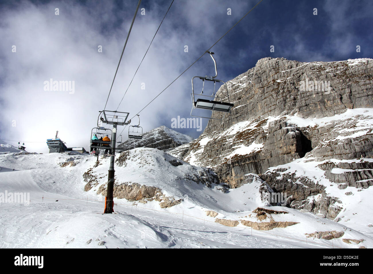 Ski-lift transports skiers to the top of the mountain on a lovely ...