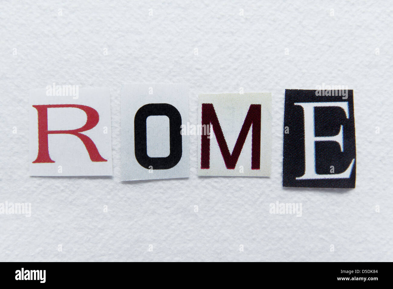 word rome cut from newspaper on white, handmade paper Stock Photo - Alamy