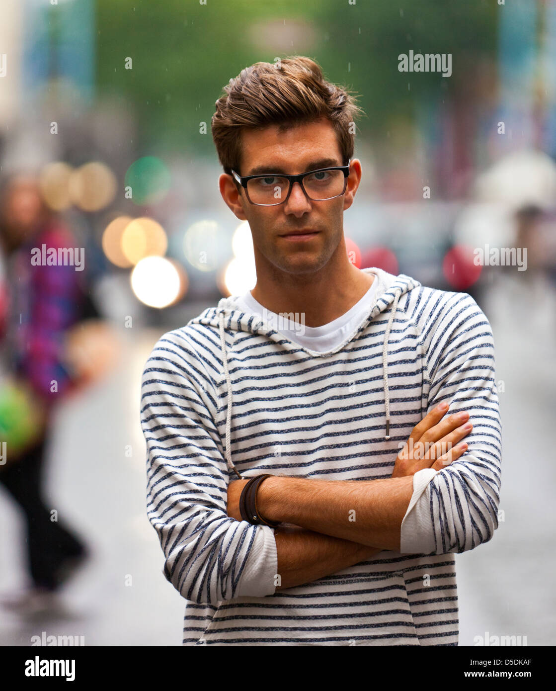 Serious looking young man on street Stock Photo - Alamy