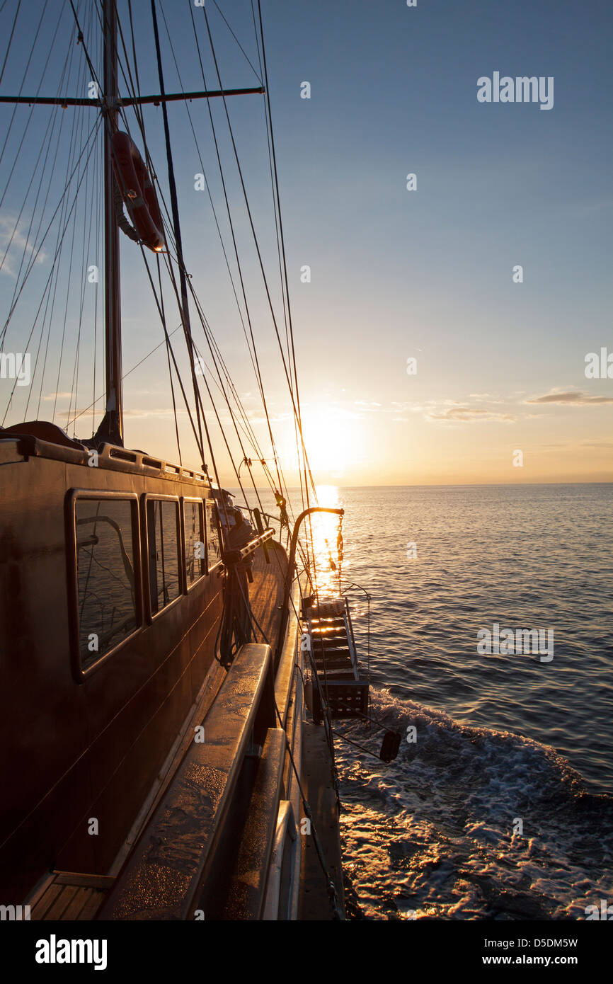 A traditional Turkish gulet ship sailing towards the sunset on the ...