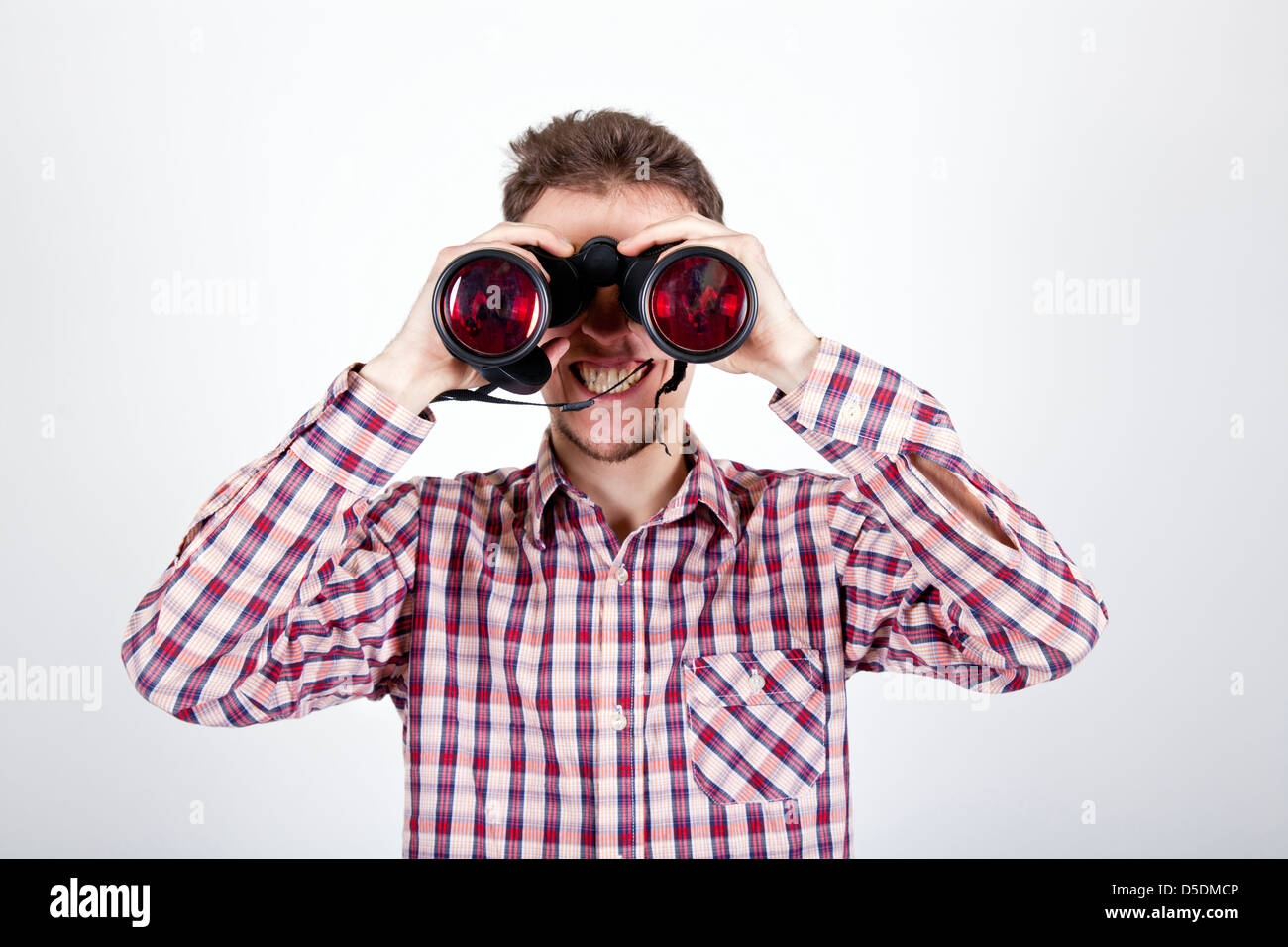 young man looking with binoculars at you Stock Photo - Alamy