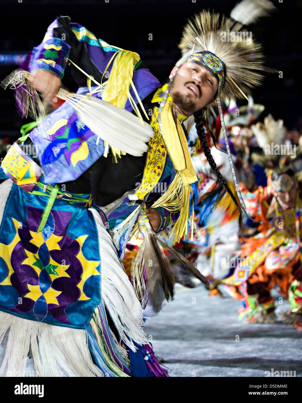 A vibrant photograph of a Native American powwow, featuring regalia ...