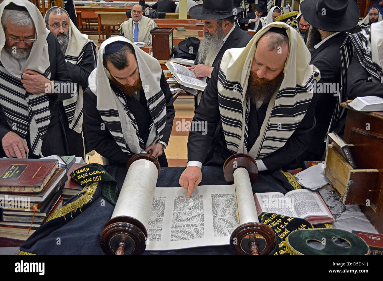 Reading from a Torah scroll at weekday morning services at Lubavitch ...