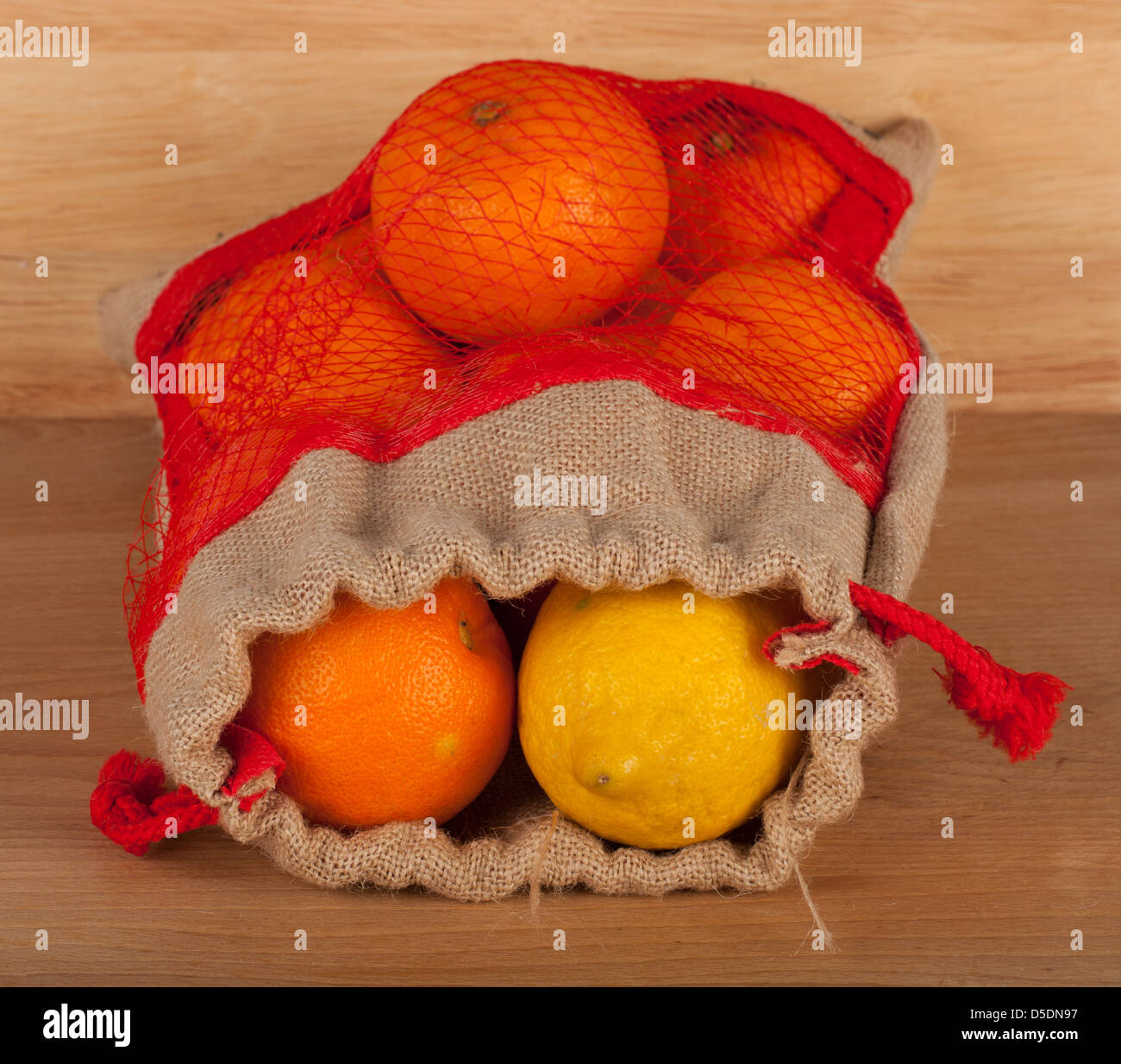 Oranges and a lemon in a small jute sack Stock Photo - Alamy