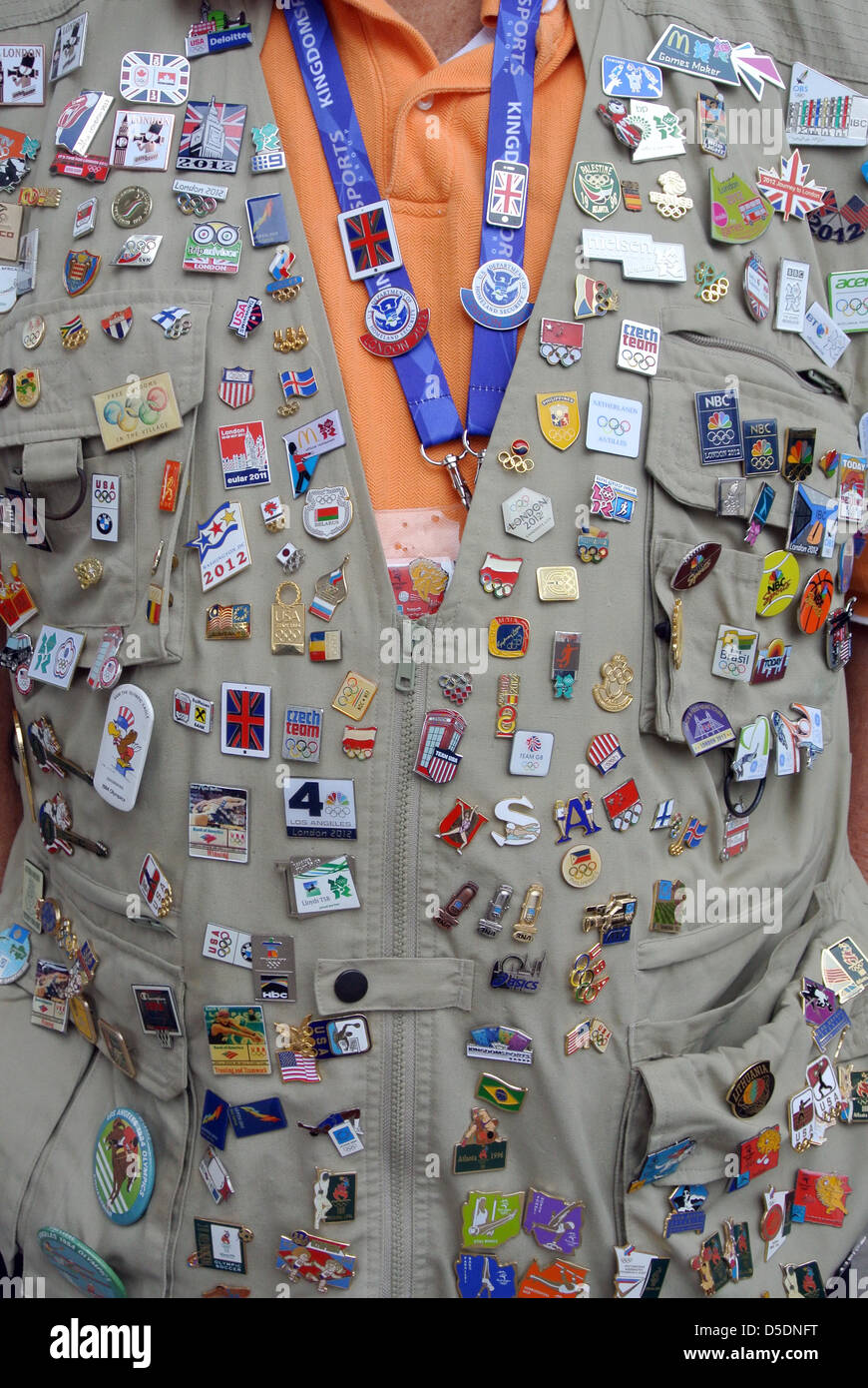 A trader wears a vest covered in pin badges. Olympic Park Stock Photo ...