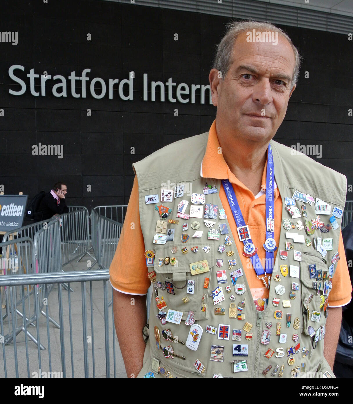 A trader wears a vest covered in pin badges outside Stratford ...