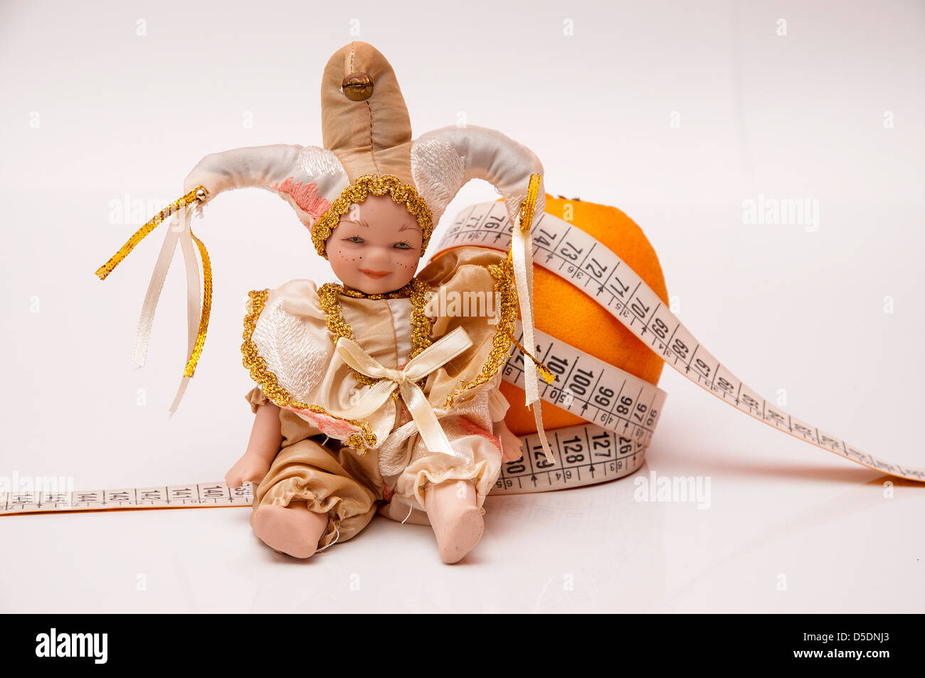 doll with orange and tape measure to measure Stock Photo - Alamy