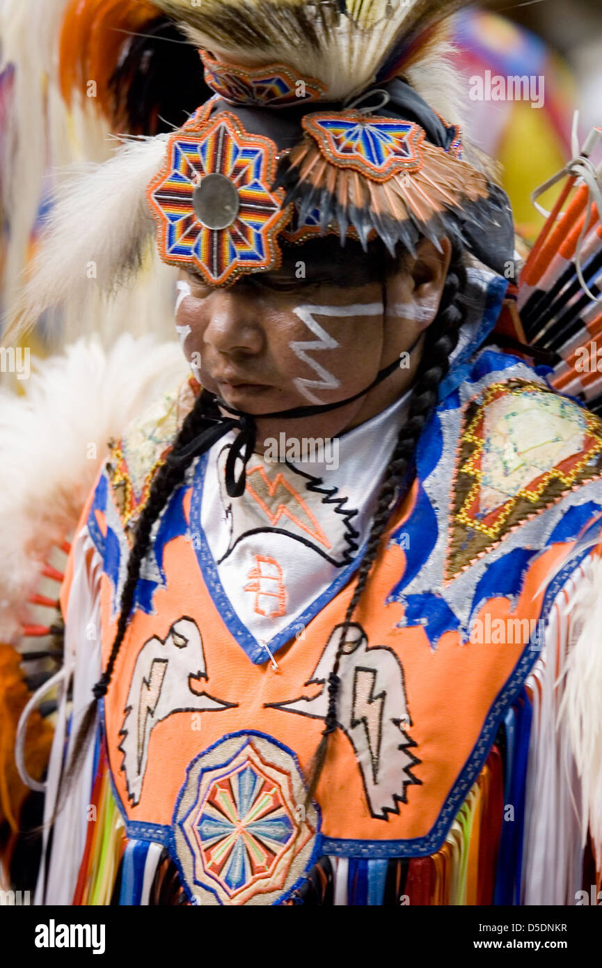 A Native American man in traditional regalia, photographed during a ...