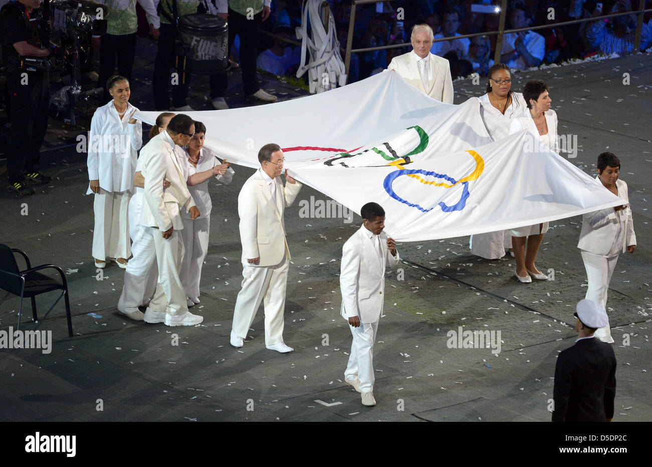 The Olympic flag is lead to the flagpole past muhammad ali (second left ...
