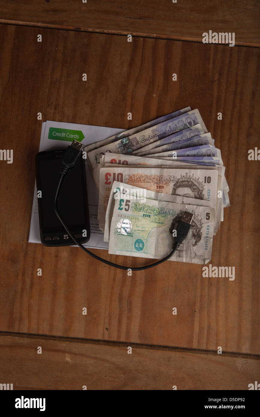 Online and mobile banking concept. USB cable and UK banknotes with ...