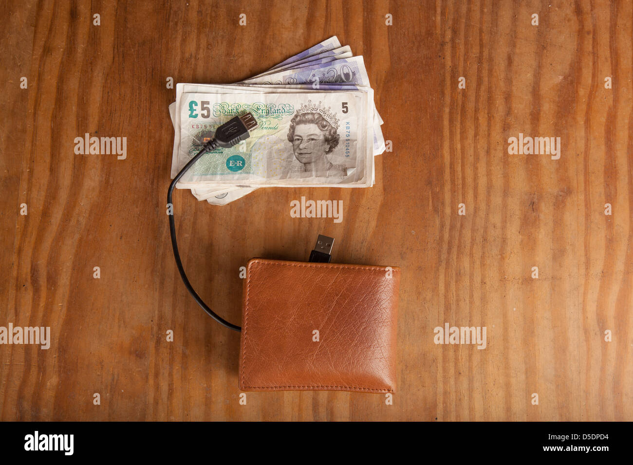 USB cable with wallet and UK banknotes. Online banking concept Stock ...