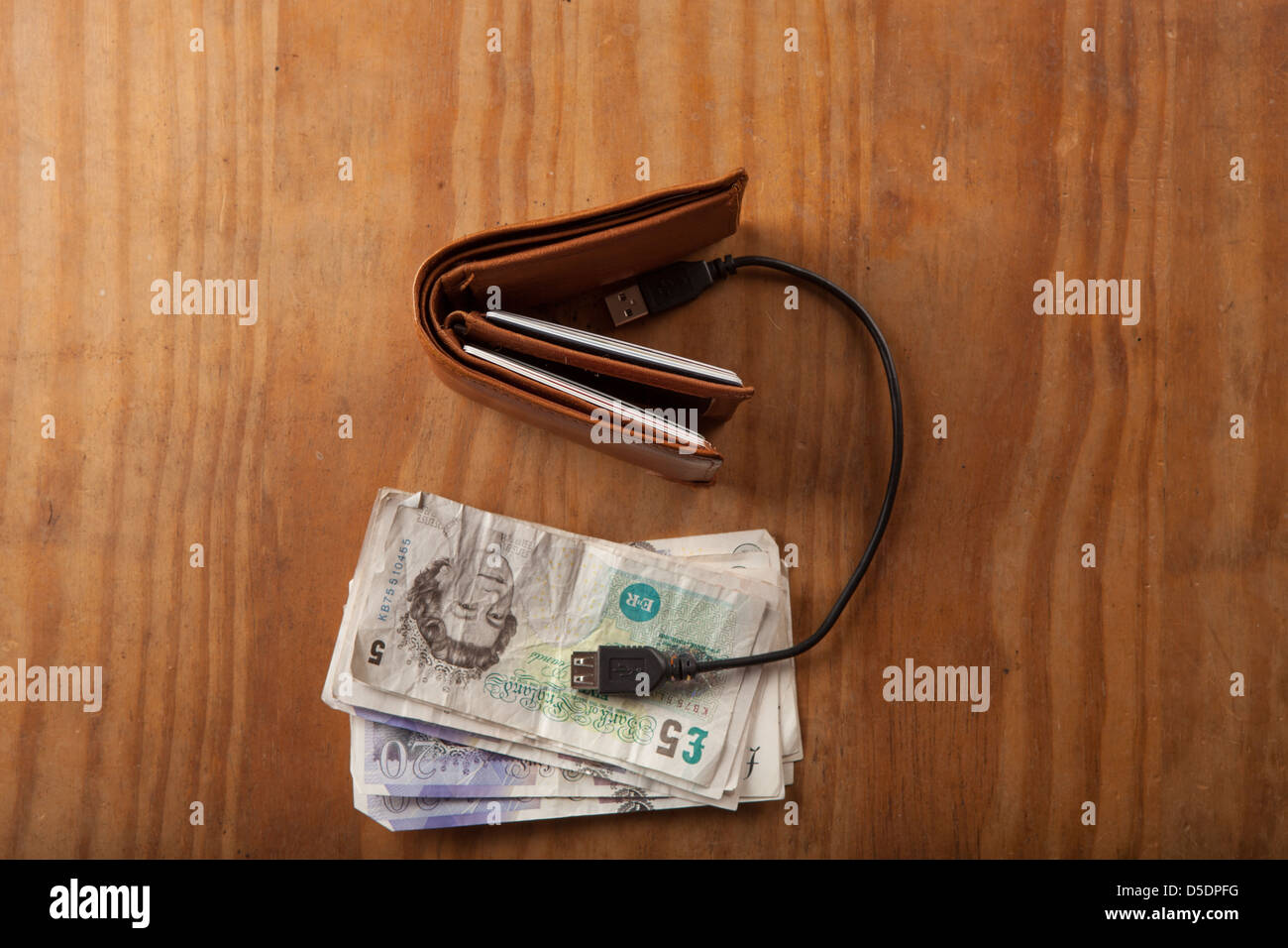 USB cable with wallet and UK banknotes. Online banking concept Stock ...