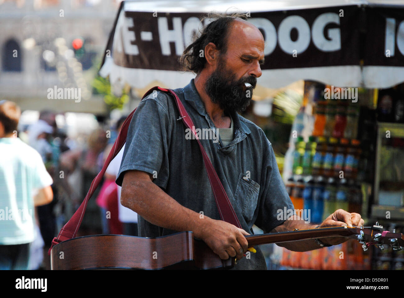 A homeless man tuning his guitar Stock Photo - Alamy