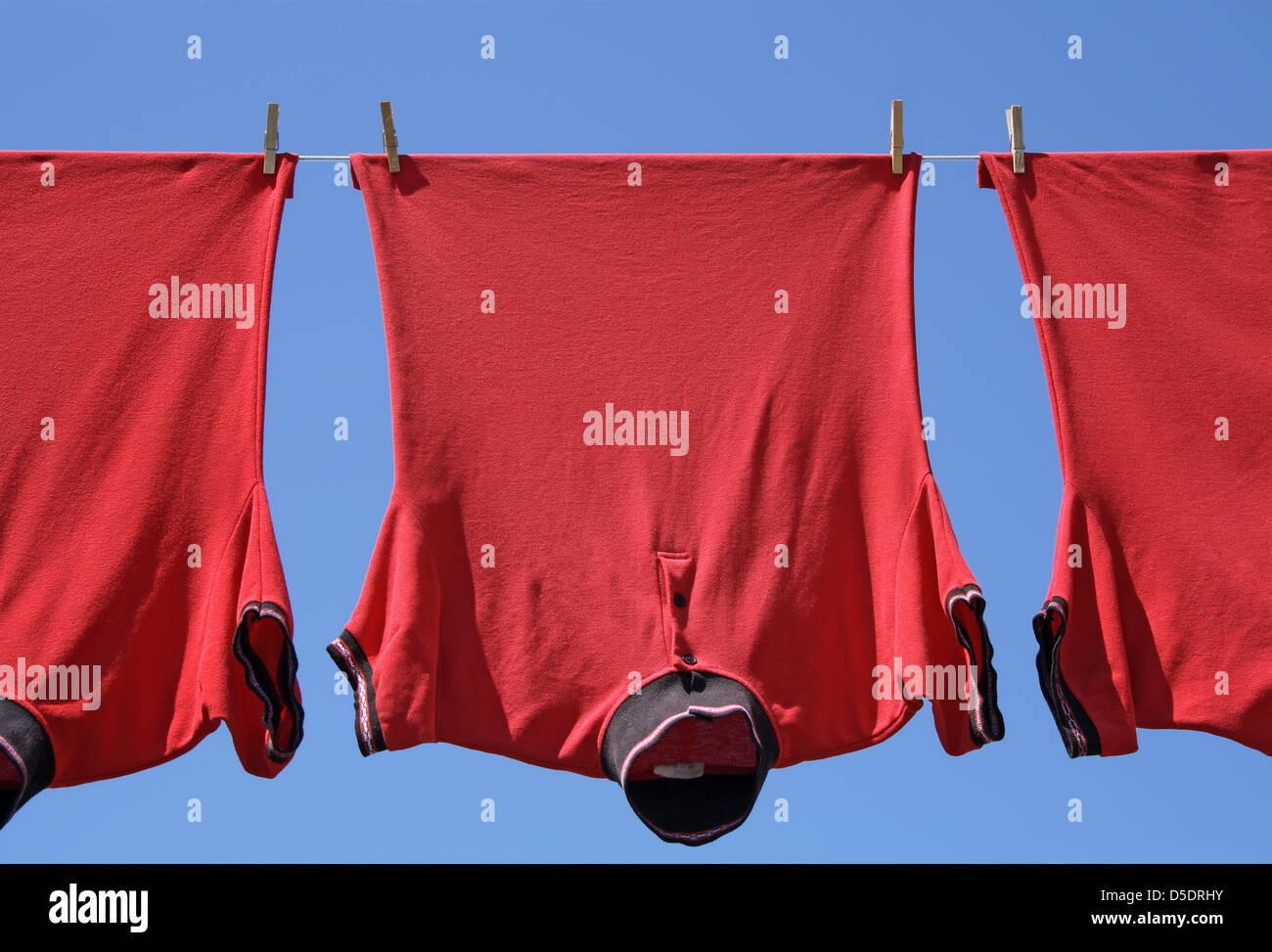 Laundry closeup, three red t-shirts on a clothes-line Stock Photo - Alamy