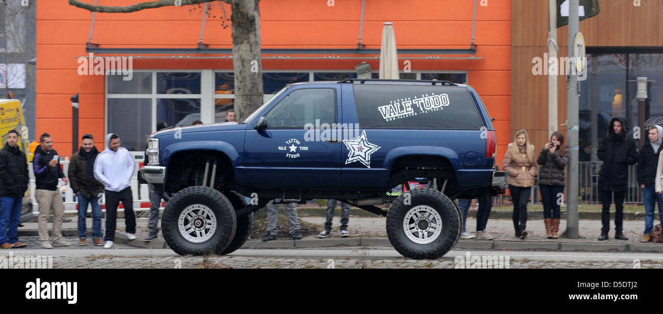 Visitors observe an exhibited vehicle at the Car Tunung Meeting in ...