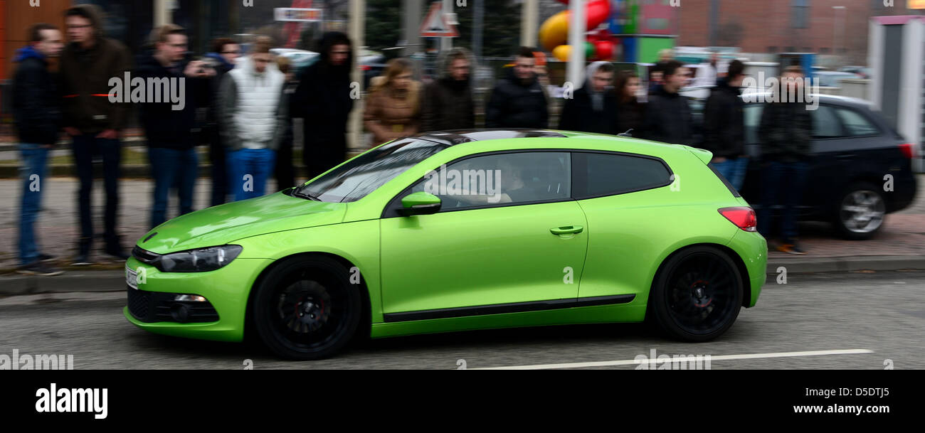 Visitors observe an exhibited vehicle at the Car Tunung Meeting in ...