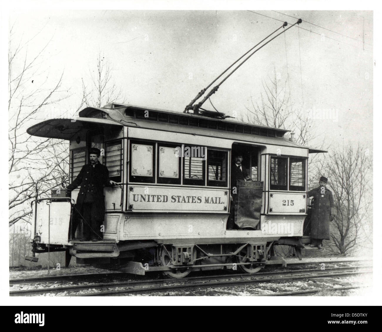 This black-and-white photograph shows a U.S. mail streetcar, an ...
