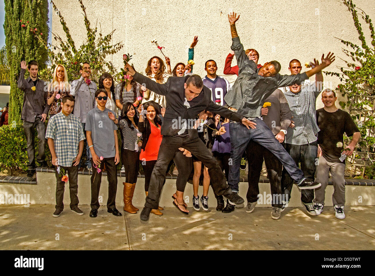 Happy graduates of a Southern California continuation high school pose ...