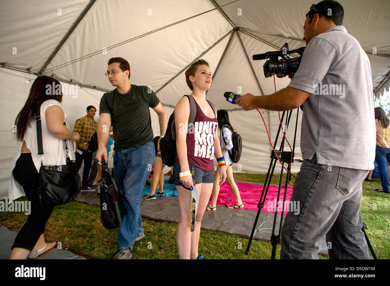 A television reporter interviews a female student during a campus ...