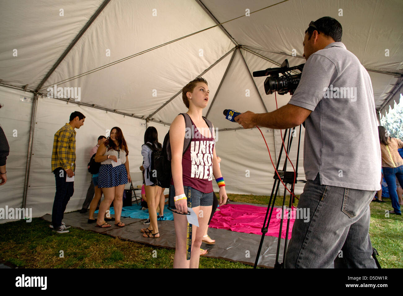 A television reporter interviews a female student during a campus ...