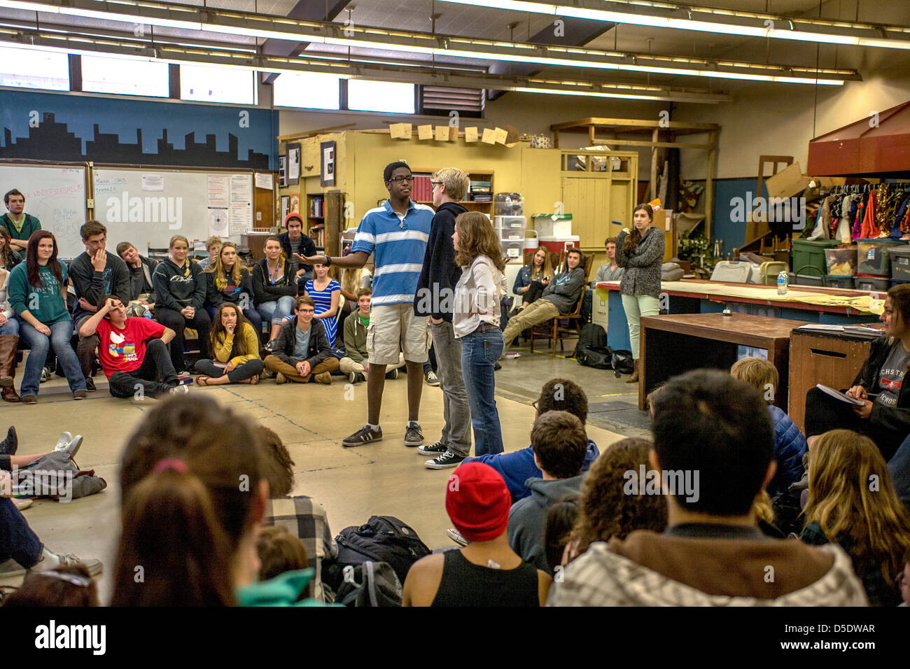 As their multiethnic classmates watch, high school drama drama students ...