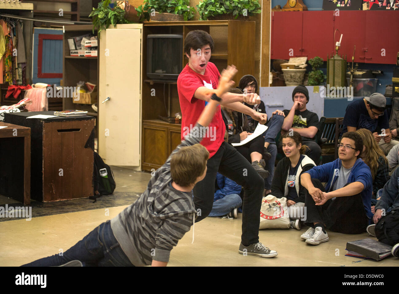 Two high school drama drama students perform improvisational theatre ...