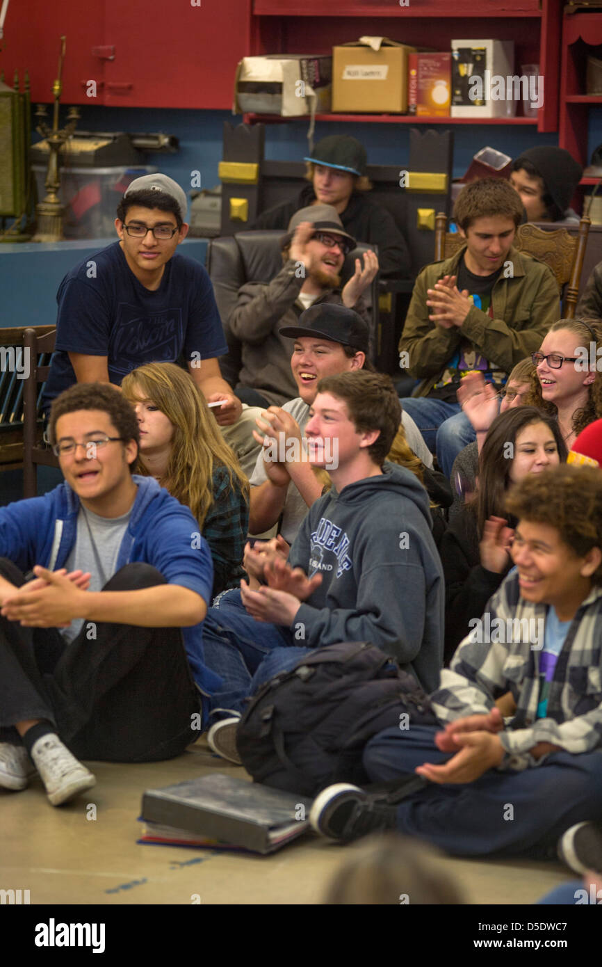 Multiethnic high school drama drama students react with applause as ...