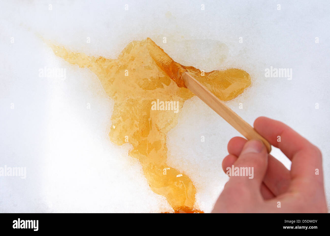 Maple taffy on snow, traditional treat in Quebec, Canada Stock Photo ...